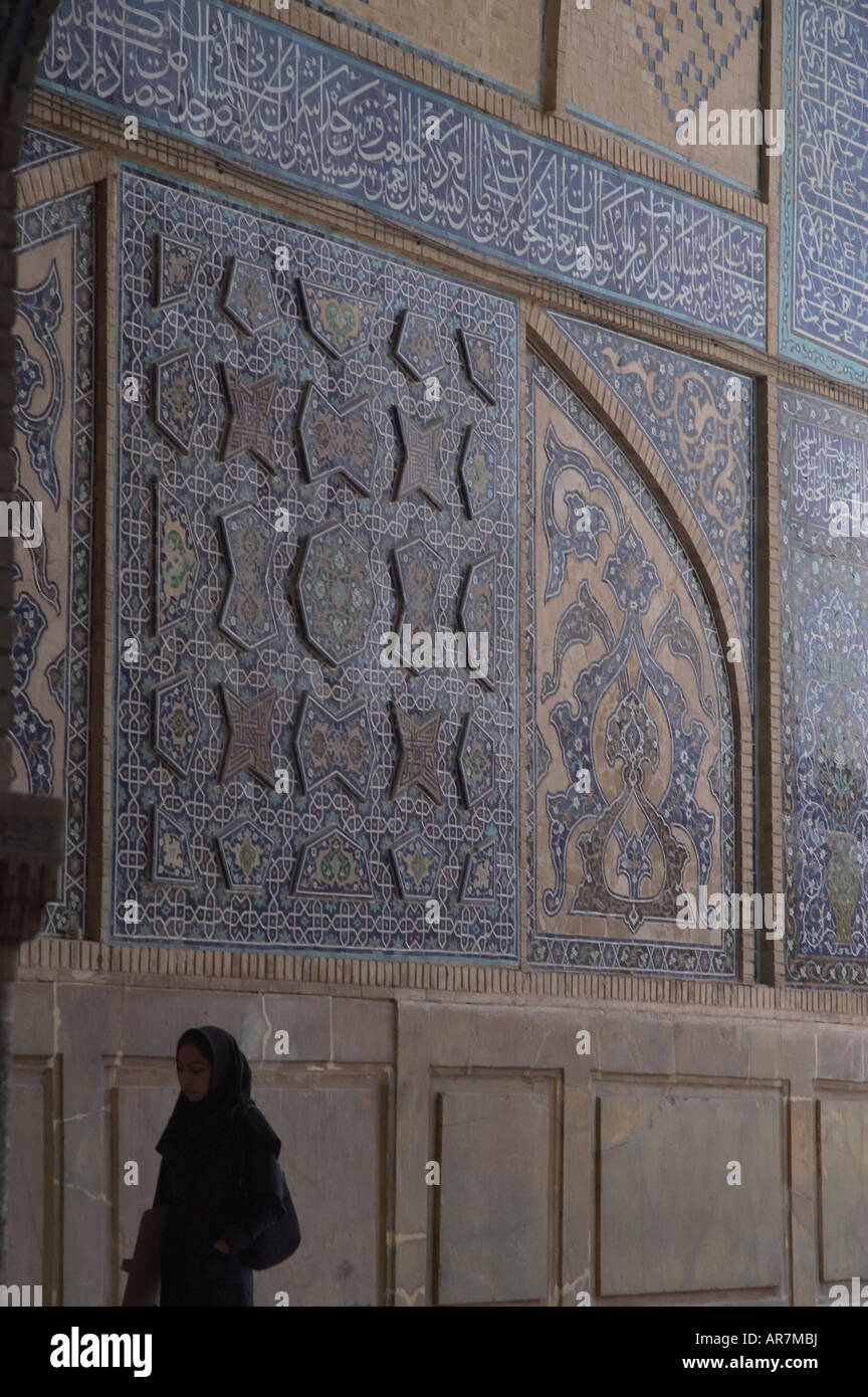 Lady wearing a black chador standing beside the pishtaq of the Masjid-i ...