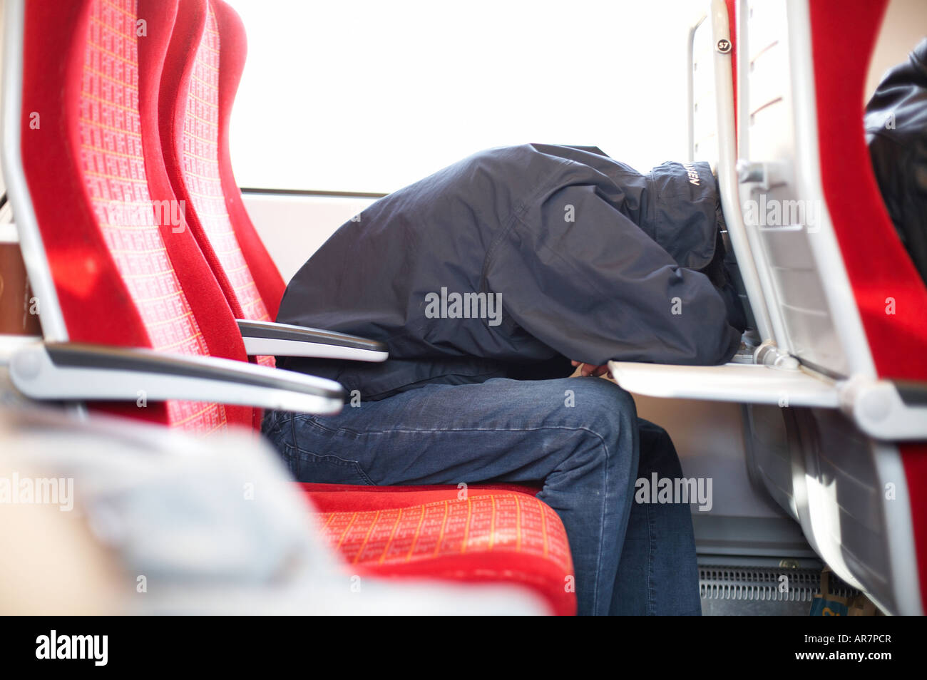 tired man sleeping on train in England UK Stock Photo - Alamy