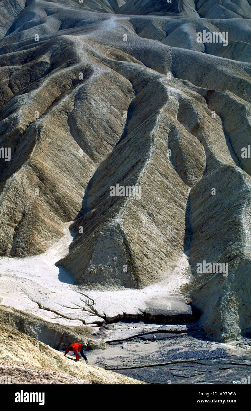 Hiker climbing up ridge at Golden Canyon, Death Valley National Park ...