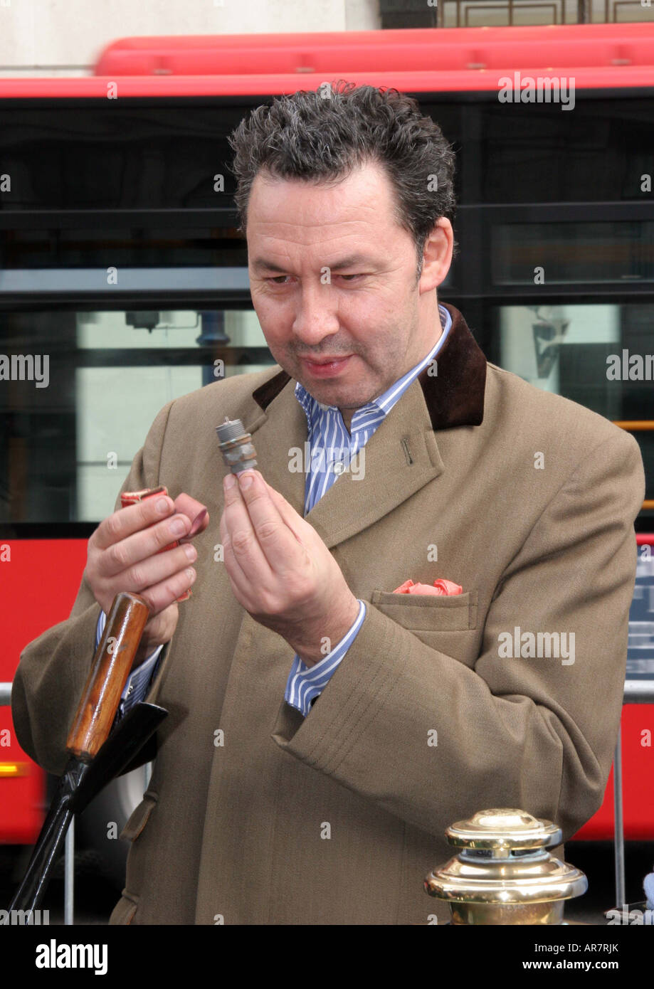 A men smartly dressed inspects an original spark plug in its box Stock ...