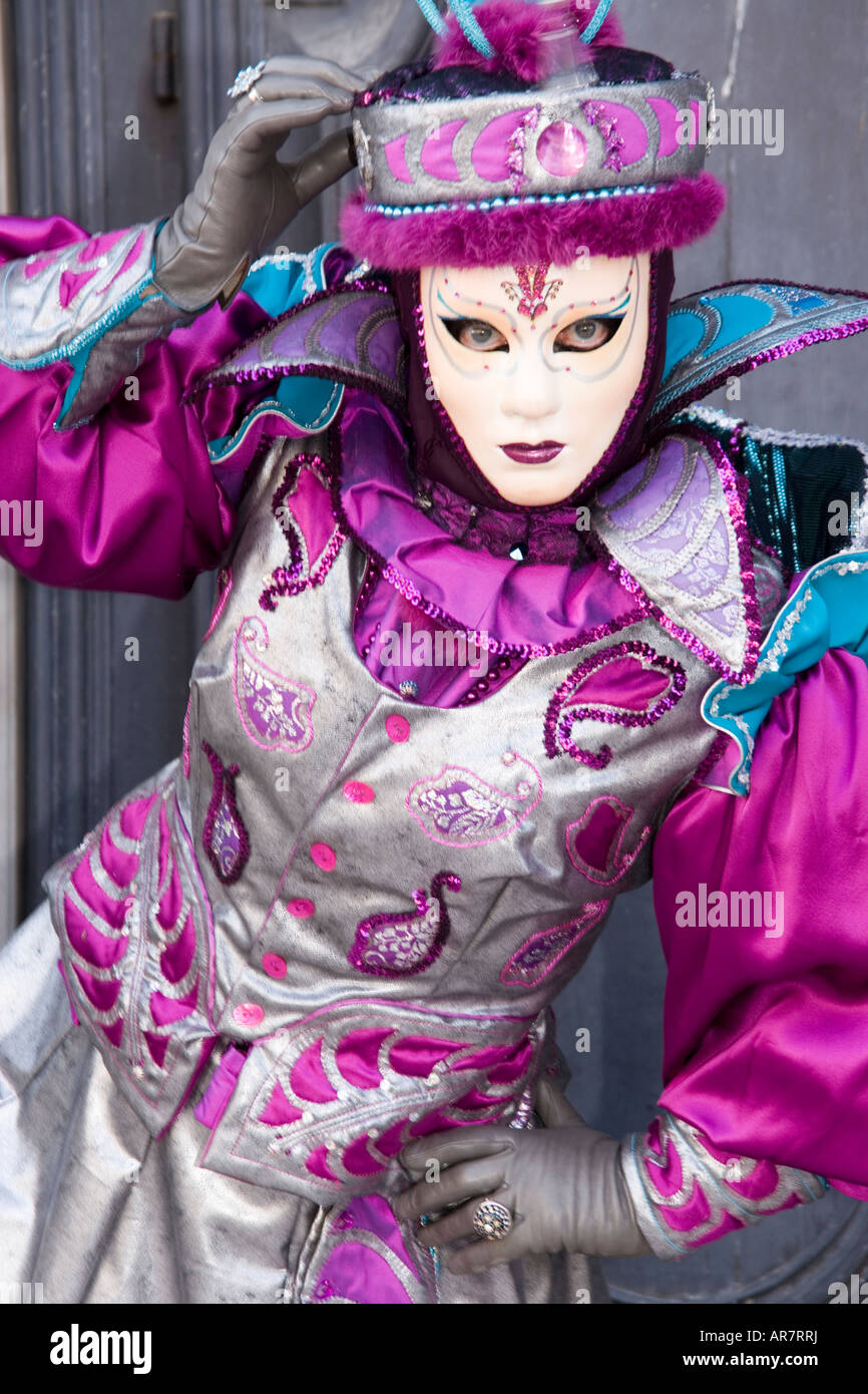 Female reveller in mask and costume by the Campanile, the Bell tower ...
