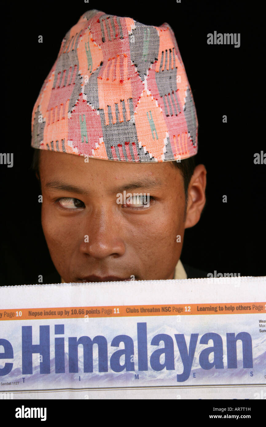 "Model reading The Himalayan news paper Nepal Stock Photo - Alamy