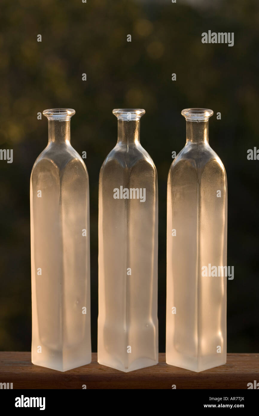 Three tall slender glass bottles make an attractive still life ...