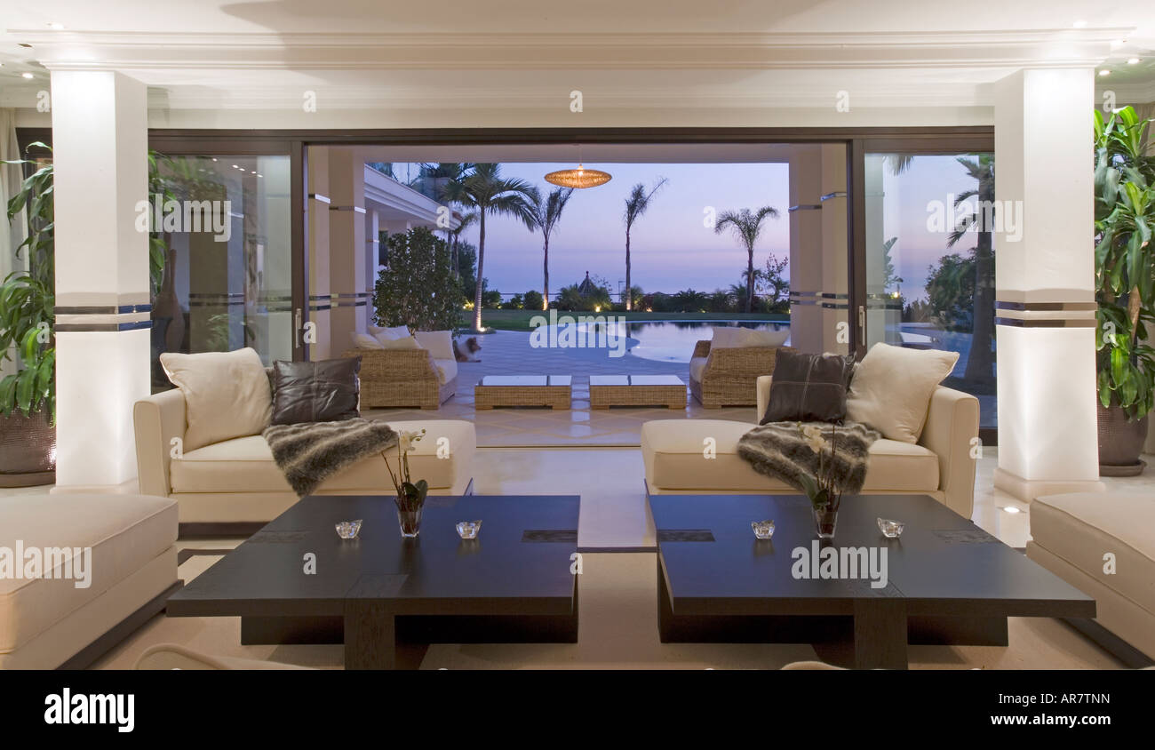 Spain, lounge in modern villa at dusk Stock Photo - Alamy