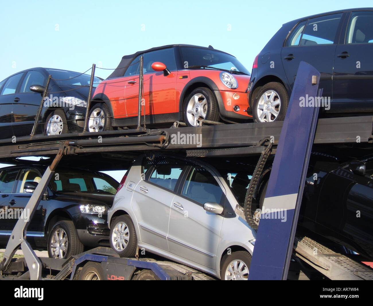 new cars on transport lorry Stock Photo - Alamy