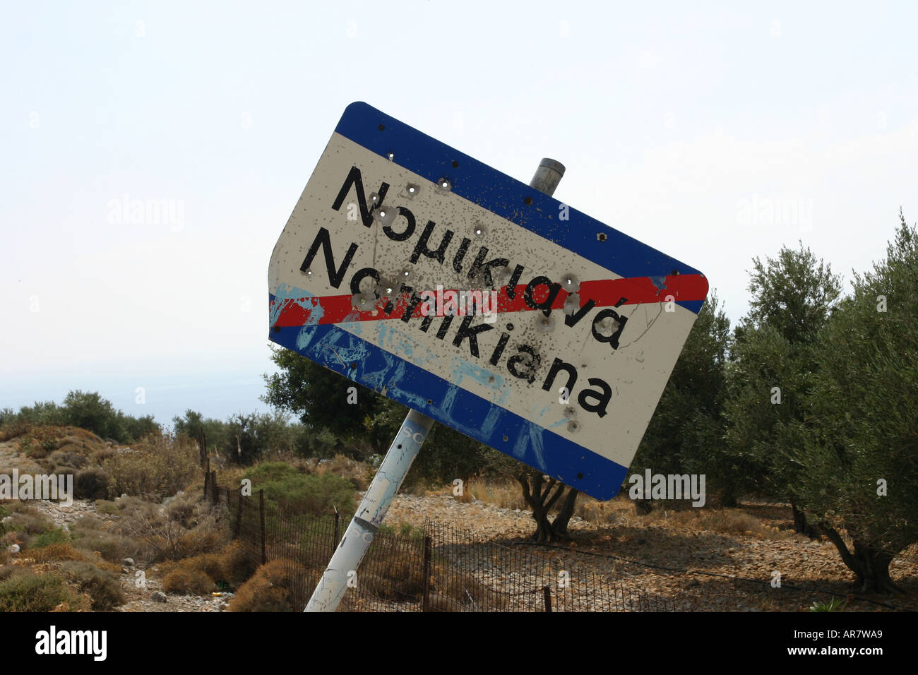 Bullet holes in road sign Crete Stock Photo - Alamy