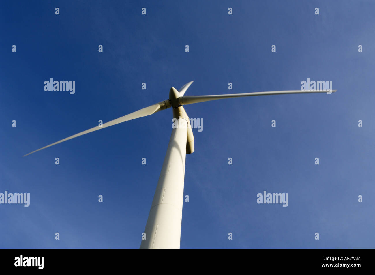 A single wind turbine set against a blue sky Stock Photo - Alamy