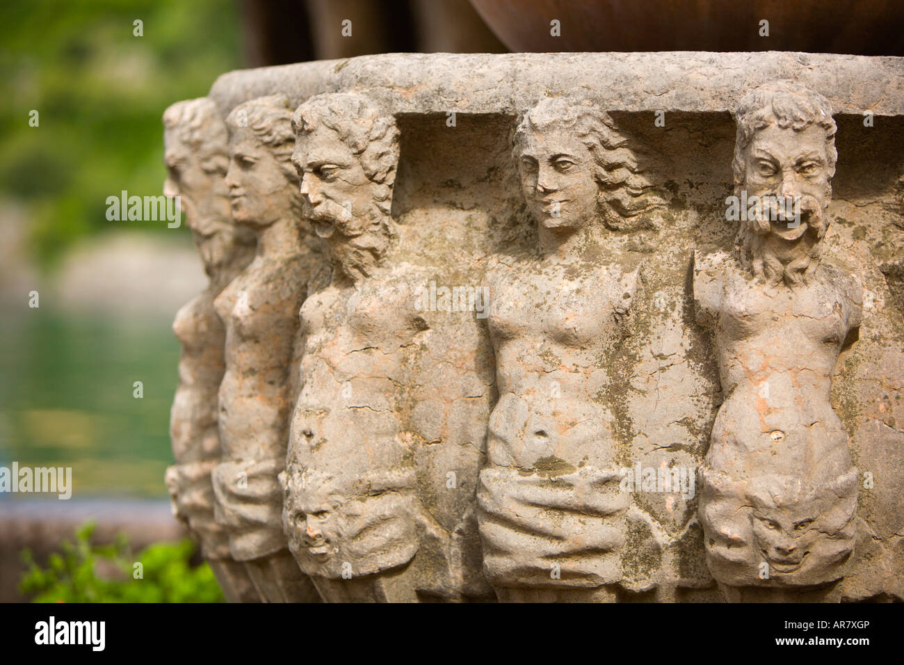 A decorative garden sculpture with multiple male figures lining its ...