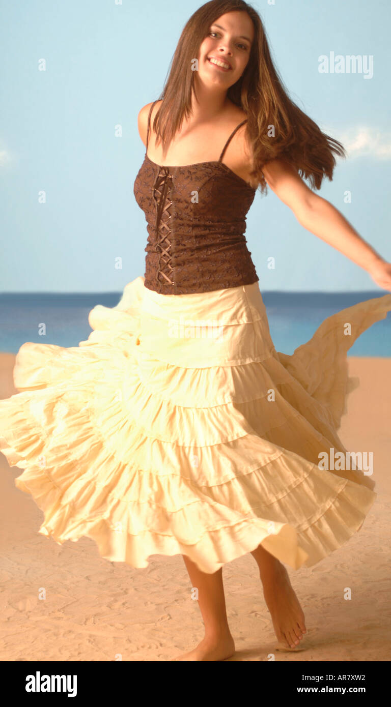 Beautiful Young Lady twirling on a Tropical Beach Stock Photo - Alamy
