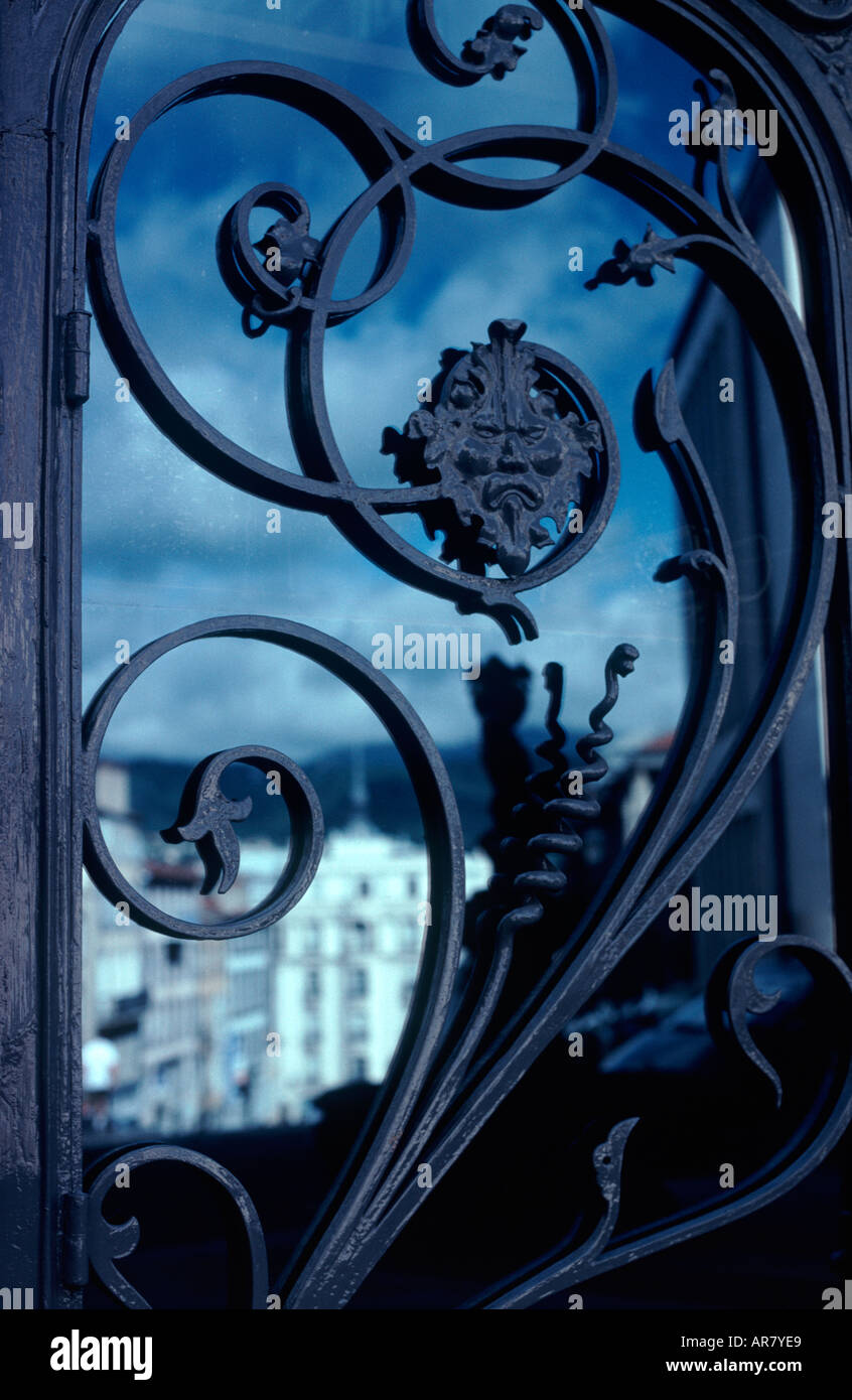 Art Nouveau ironwork and city reflection in window of pharmacy, Place ...