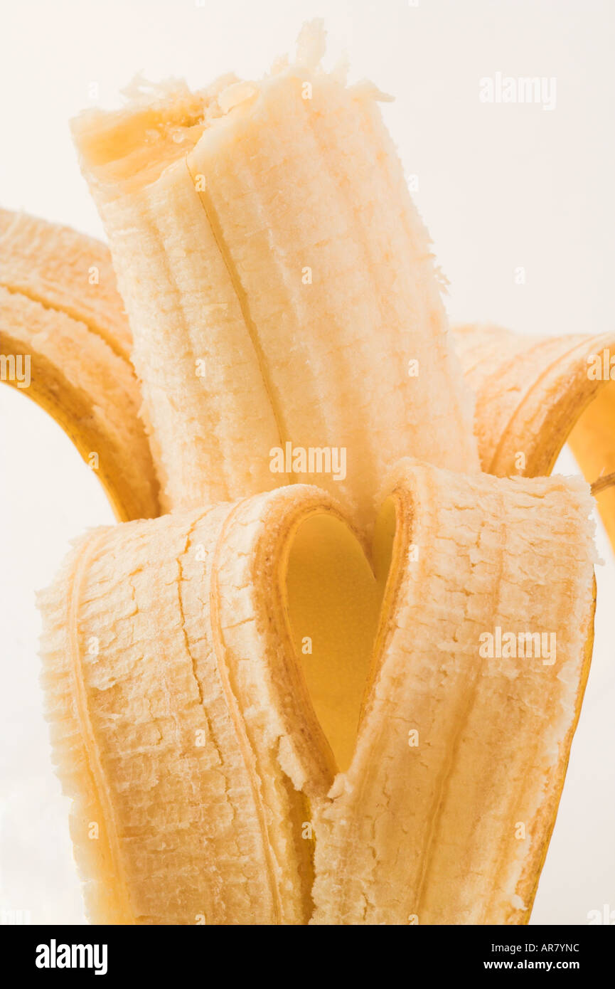 a half peeling and biting banana Stock Photo - Alamy