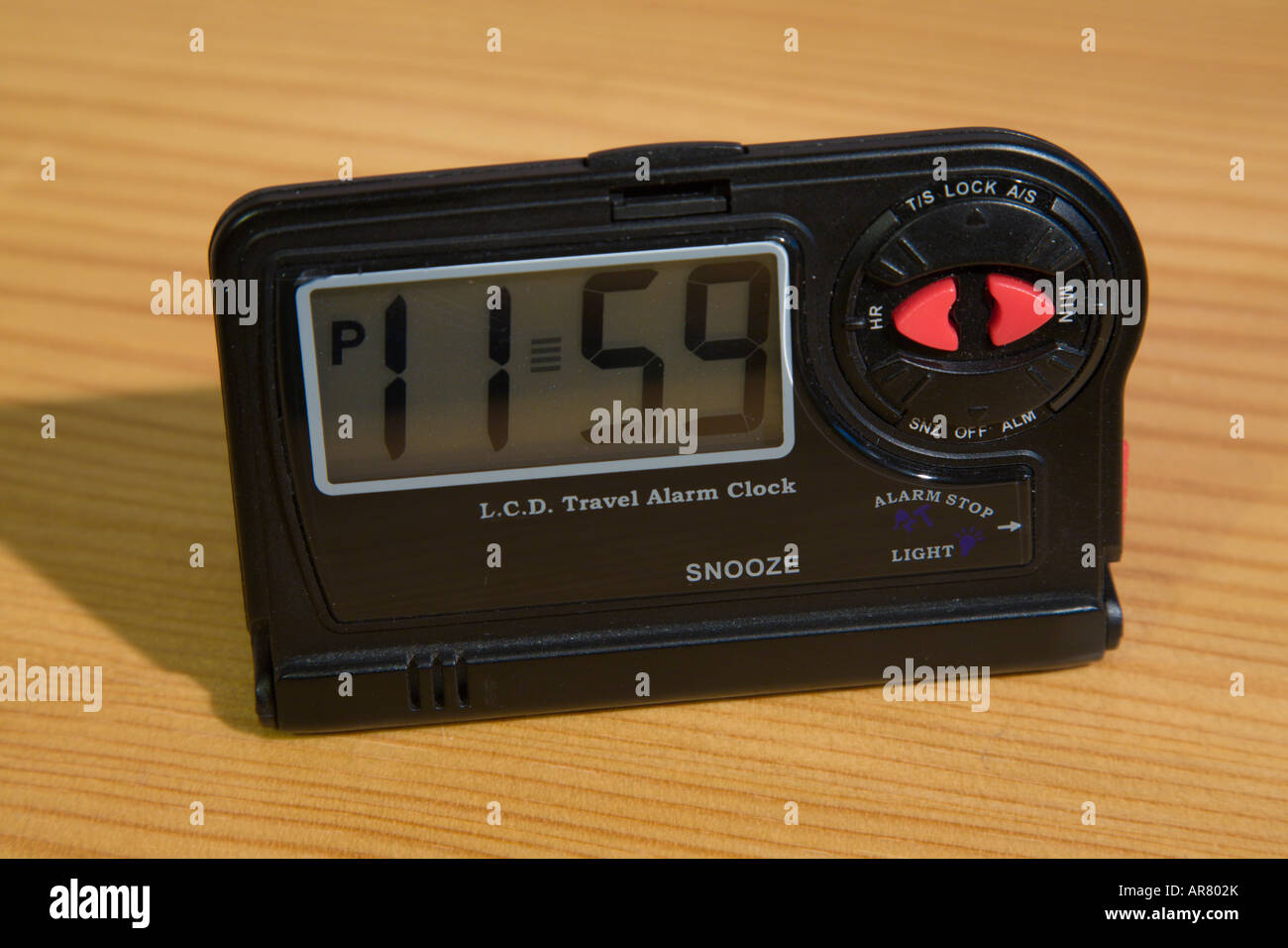 Digital alarm clock showing one minute to midnight Stock Photo - Alamy