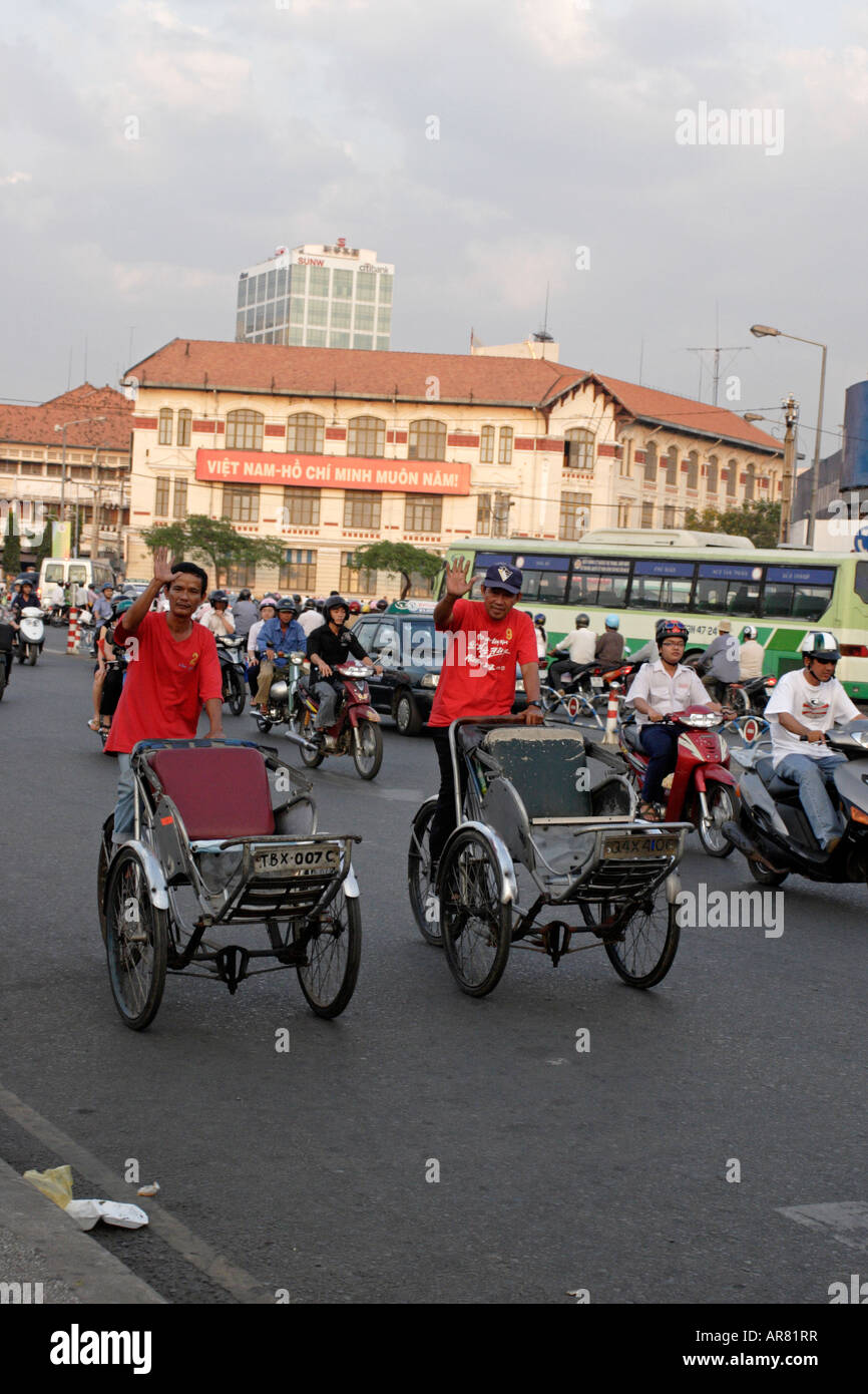 Two Cyclo drivers wave on the streets of Ho Chi Minh City, Vietnam ...
