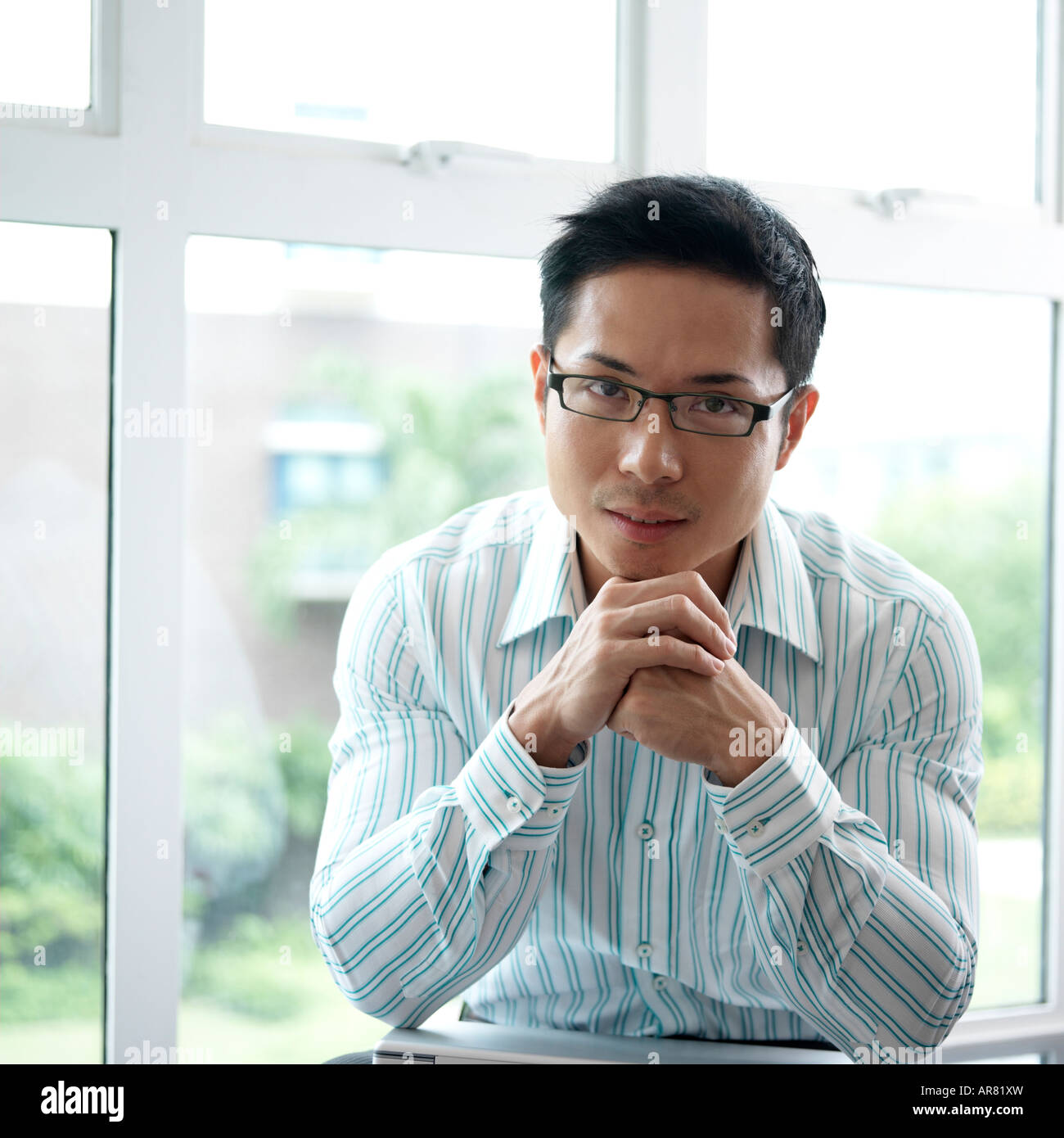 Man sitting with head in hands Stock Photo - Alamy