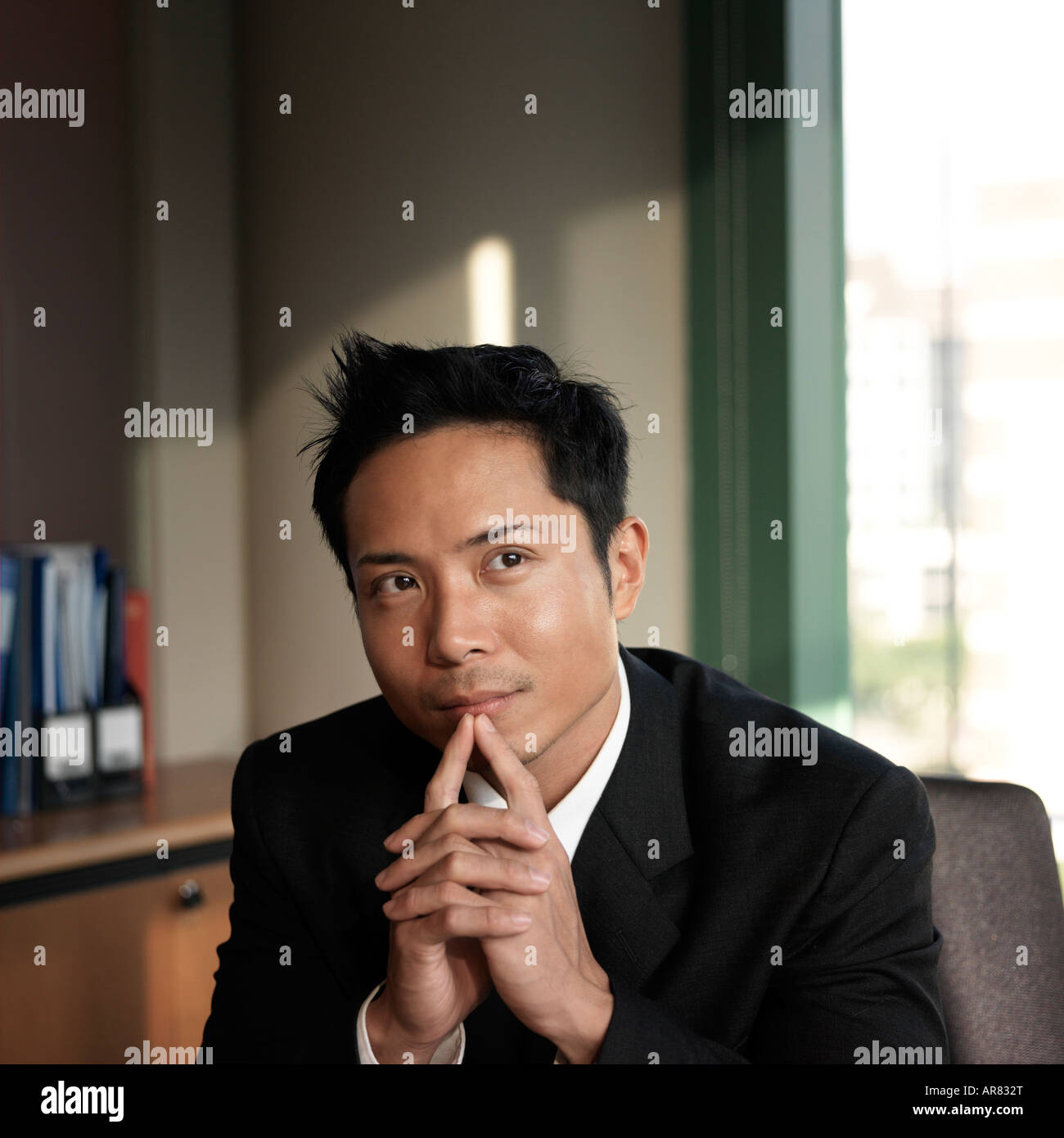 Portrait of businessman thinking Stock Photo - Alamy