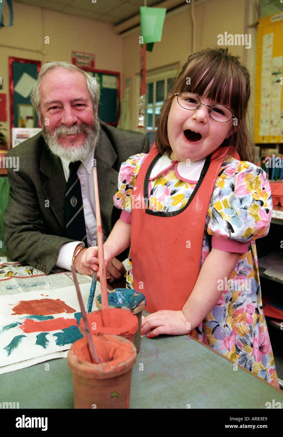 Headmaster of primary school with pupil during Art class Stock Photo ...