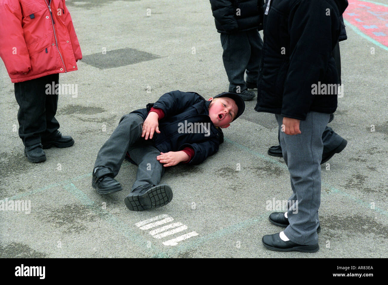 Accident in the playground Child fallen over during a game a football ...