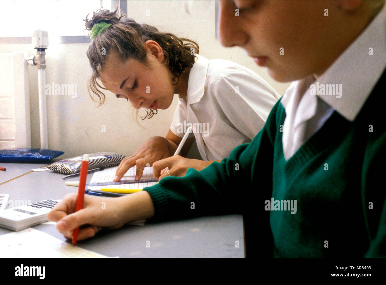 Two girls working on schoolwork in the classroom Stock Photo - Alamy