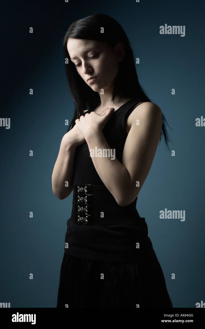Emotive portrait of a young woman on a blue background Stock Photo - Alamy