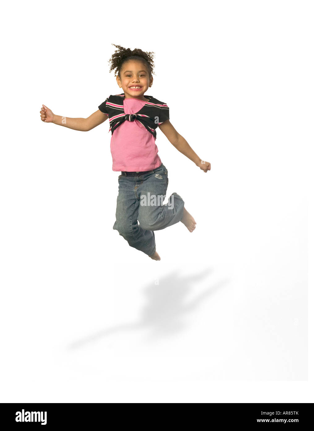 African American young girl jumping with enthusiasm Stock Photo - Alamy