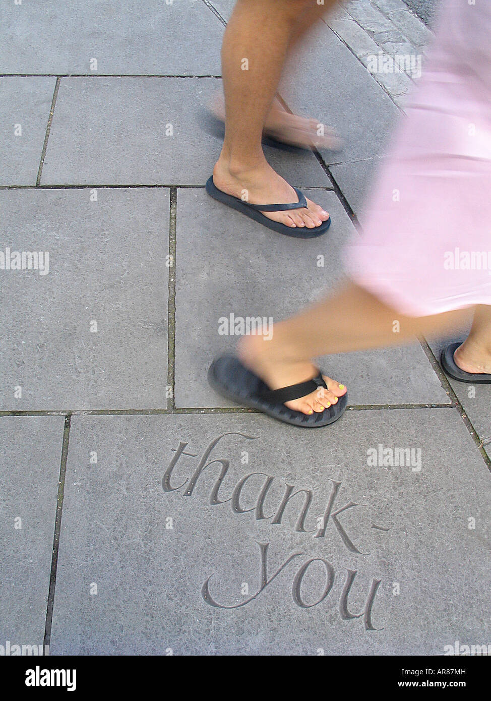 Pedestrians on an engraved pavement Stock Photo - Alamy
