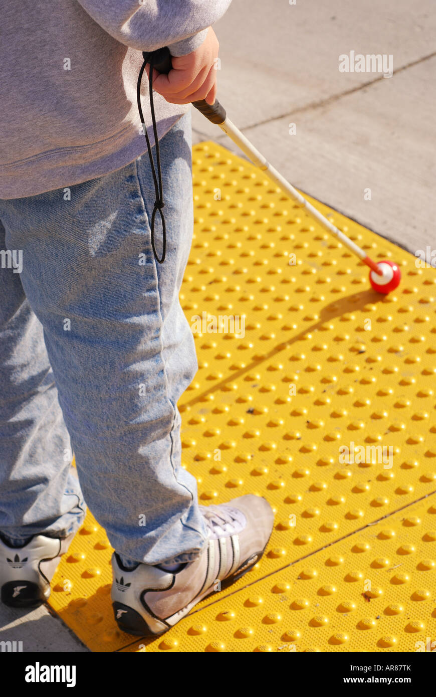 Blind woman standing on a crosswalk platform Stock Photo - Alamy