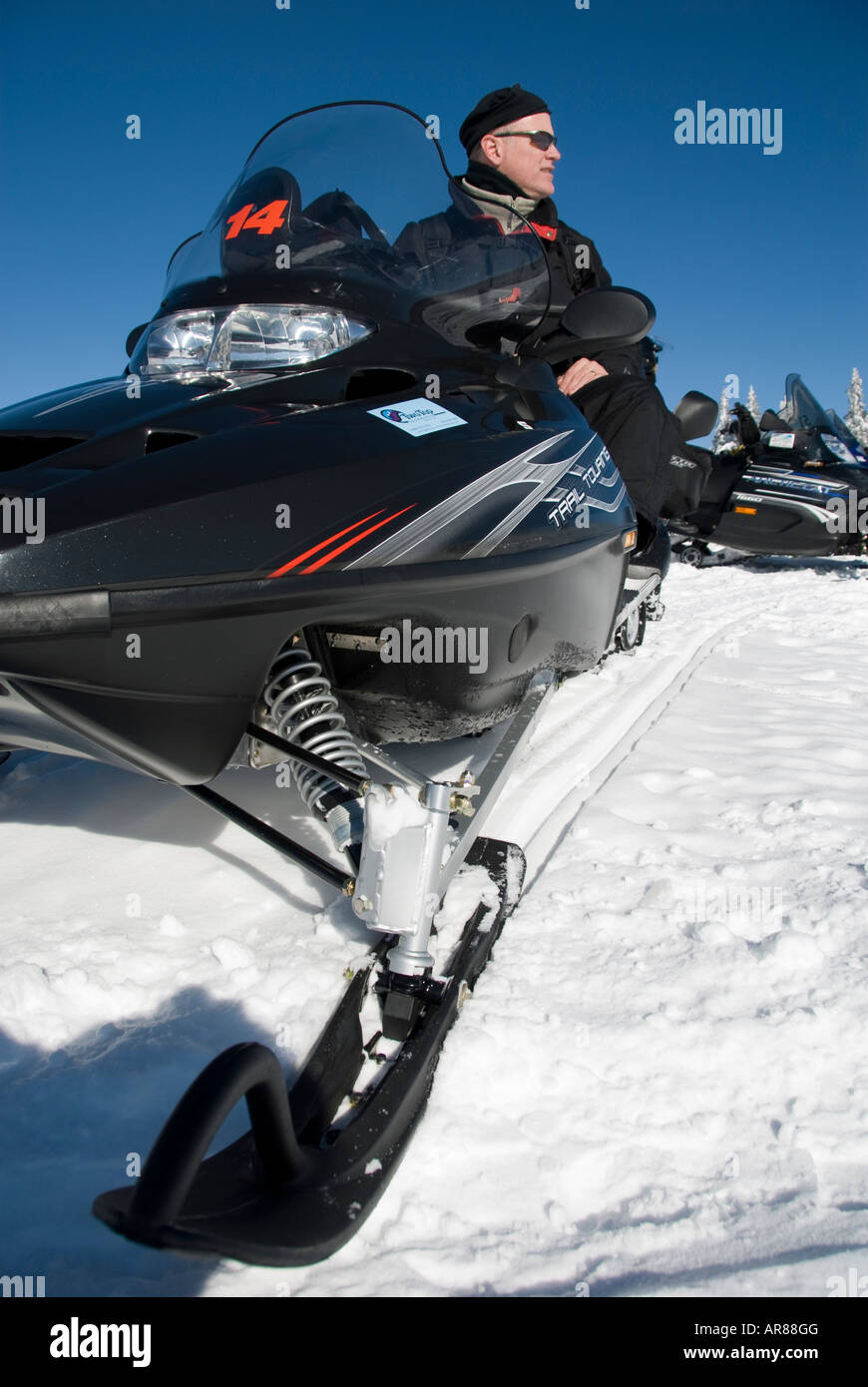 Rider sits atop his snowmobile along the Two Top Loop Trail, West ...