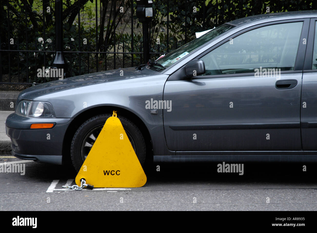 Yellow wheel clamp on parked car in London England UK Stock Photo - Alamy