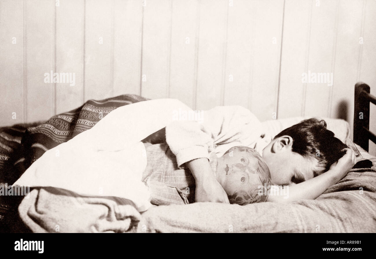 Vintage Photo of Boy Sleeping With Doll Stock Photo - Alamy