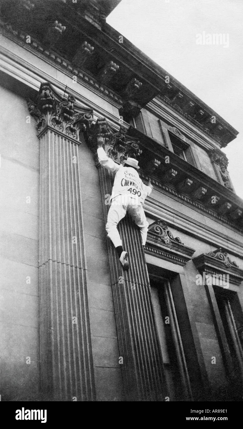 Vintage Photo of Man Scaling Wall Of Building Stock Photo - Alamy