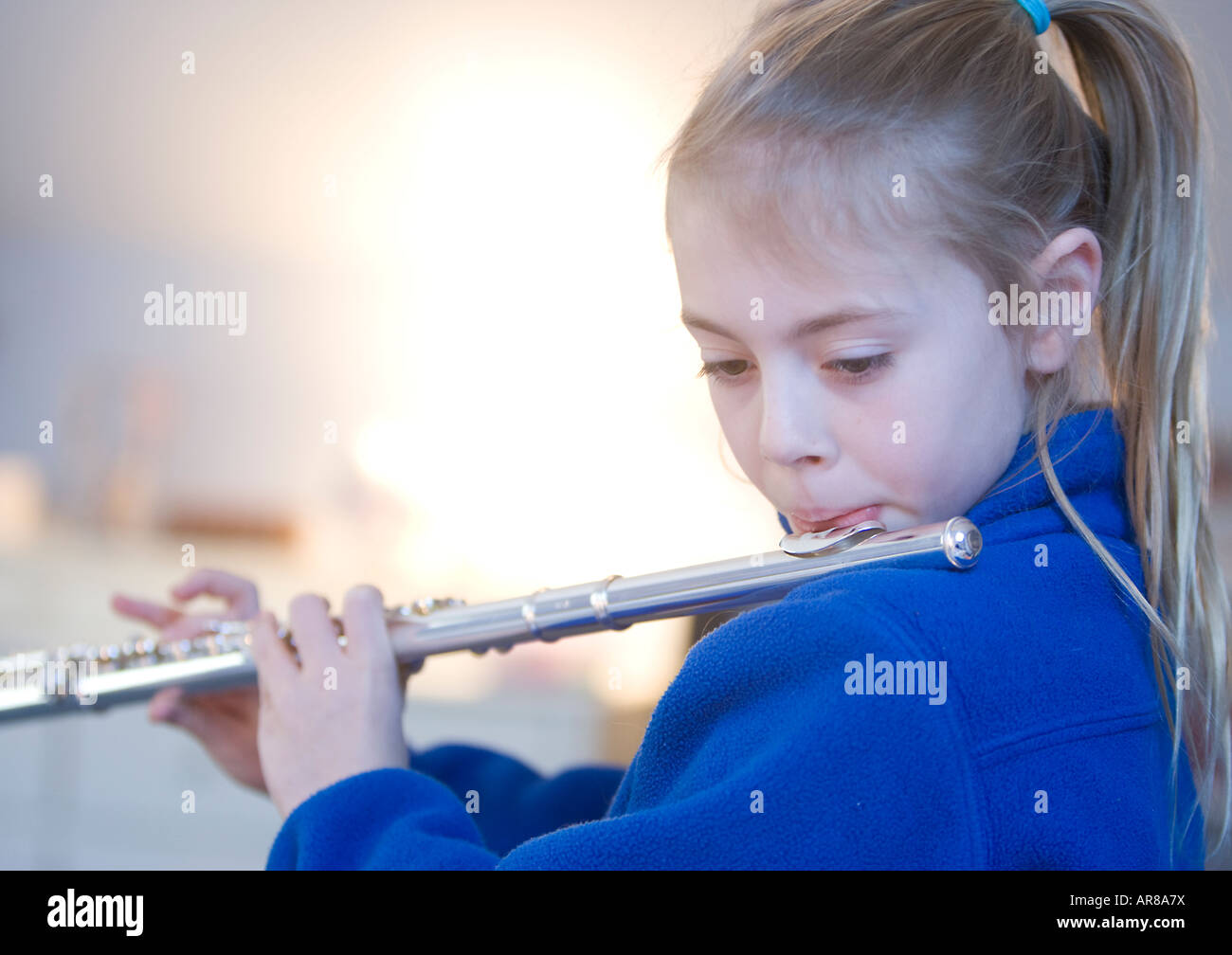 Child practicing playing a flute Stock Photo - Alamy