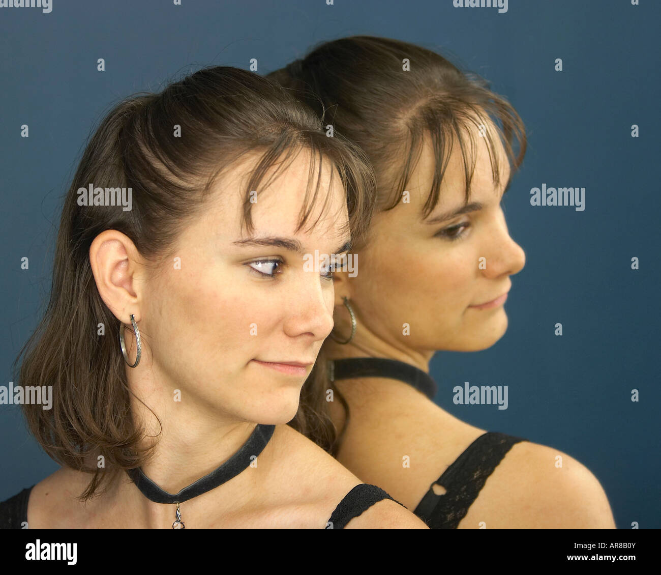 A cute young caucasian woman with her reflection in a mirror Stock ...