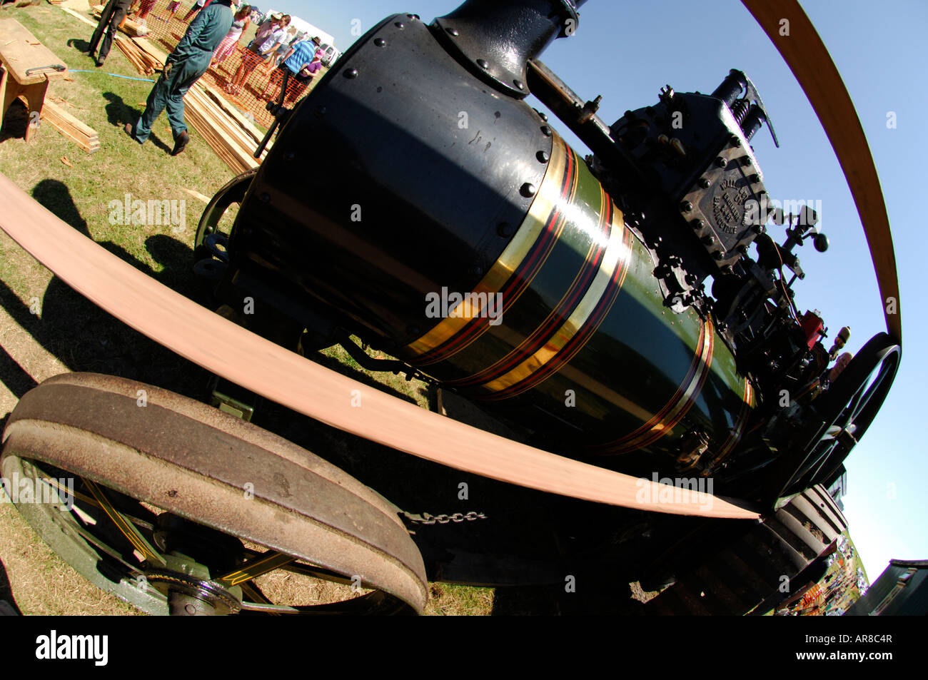 a steam traction enginge powering a threshing machine at a steam rally ...