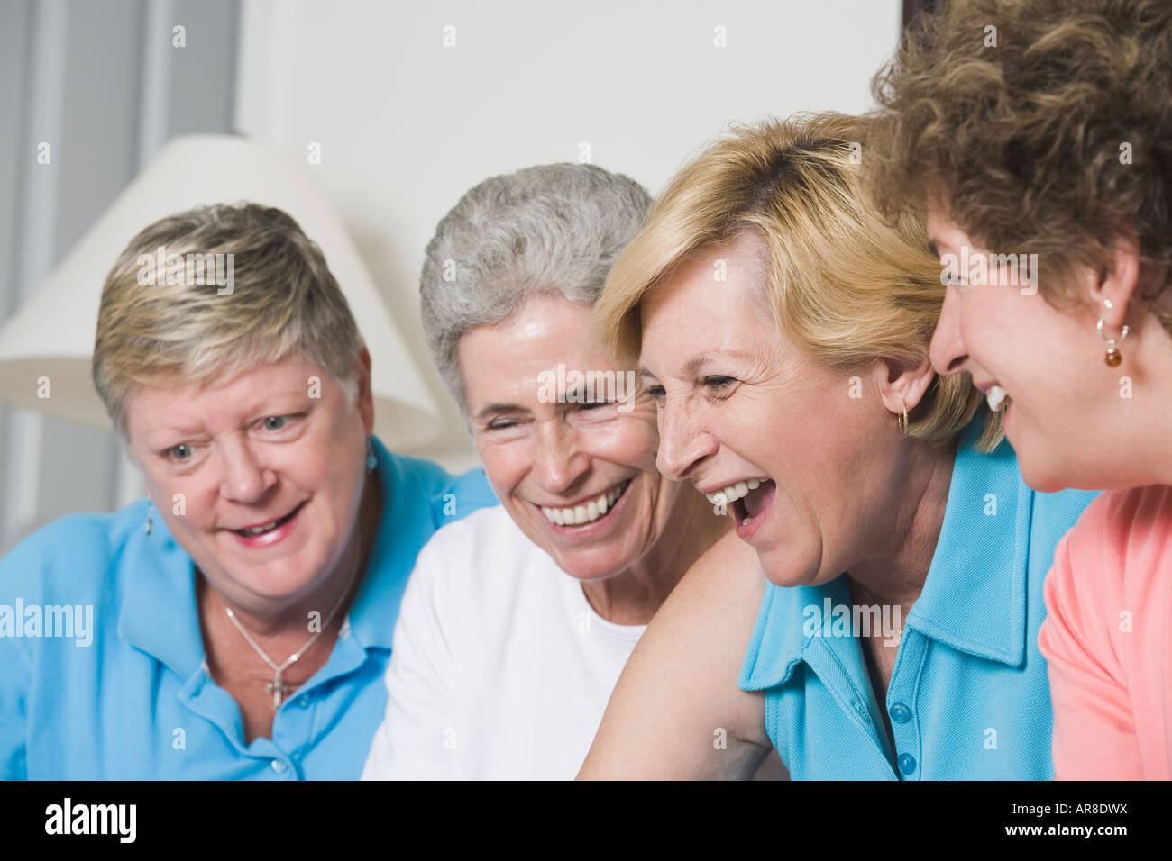 Four middle-aged women laughing Stock Photo - Alamy