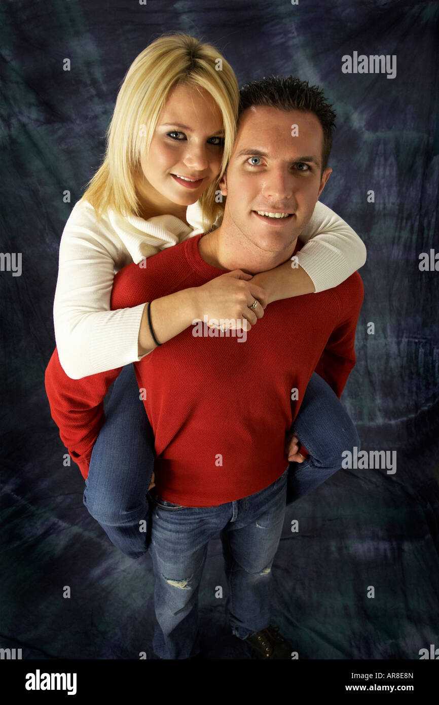 A happy young couple woman on man's back Stock Photo - Alamy
