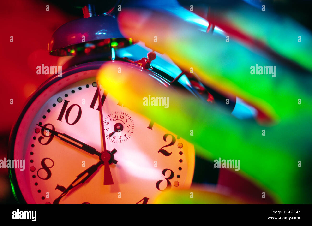 Hand reaching to switch off alarm clock Stock Photo - Alamy