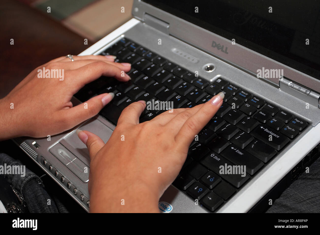 A young woman's hands typing on a notebook computer Stock Photo - Alamy