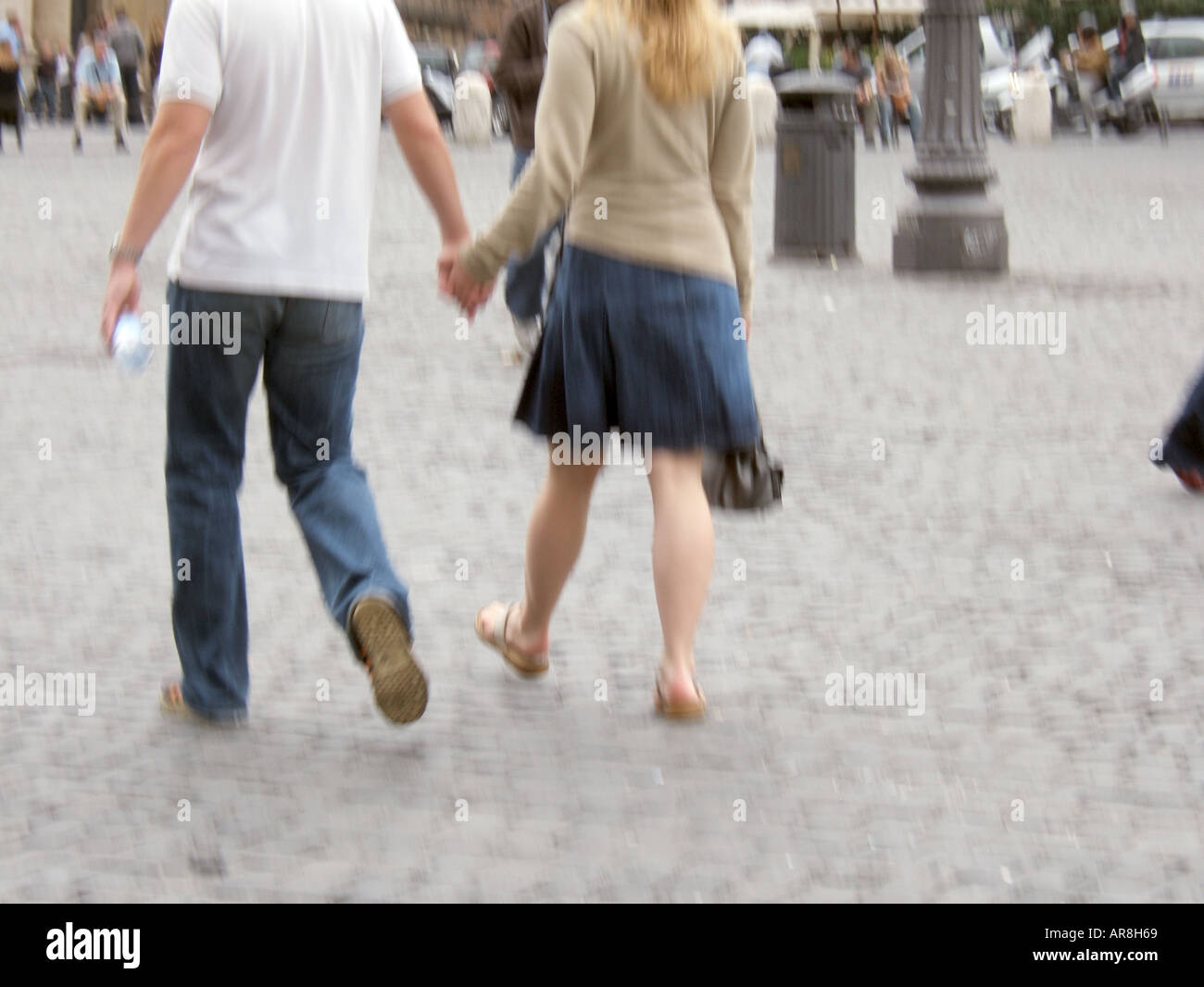 couple walking holding hands Stock Photo - Alamy