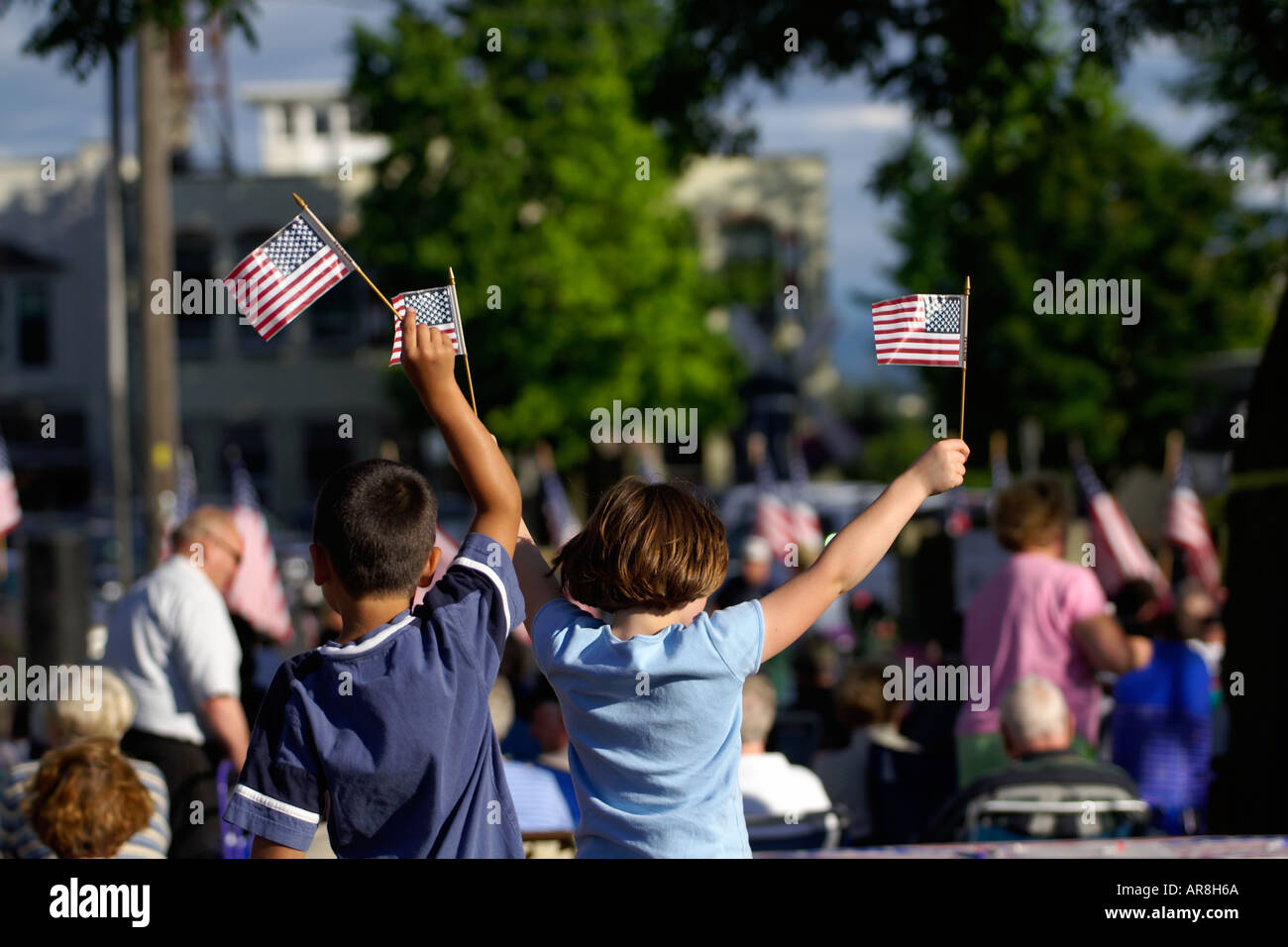 two children waving small US flags at July fourth celebration Stock ...