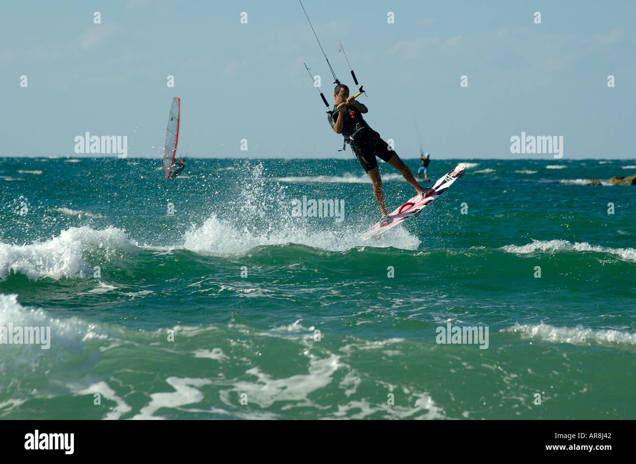 A kite boarder athlete performing unhooked freestyle kite boarding ...