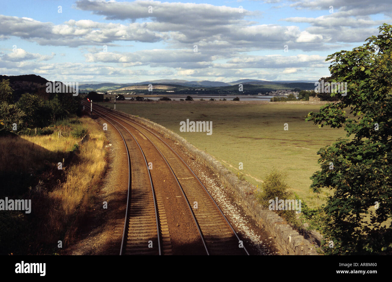 Raiway line as it curves around Morecambe Bay at Grange Stock Photo - Alamy