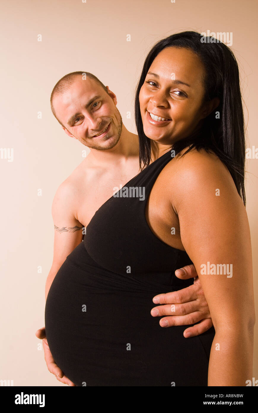 Pregnant black woman with white partner Stock Photo - Alamy