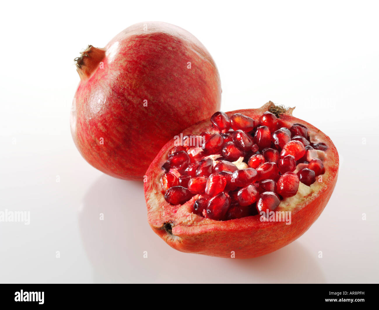 half a pomegranate showing seeds Stock Photo - Alamy