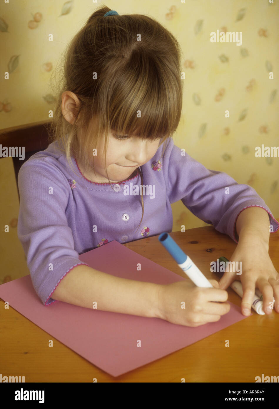 Young girl writing Stock Photo - Alamy