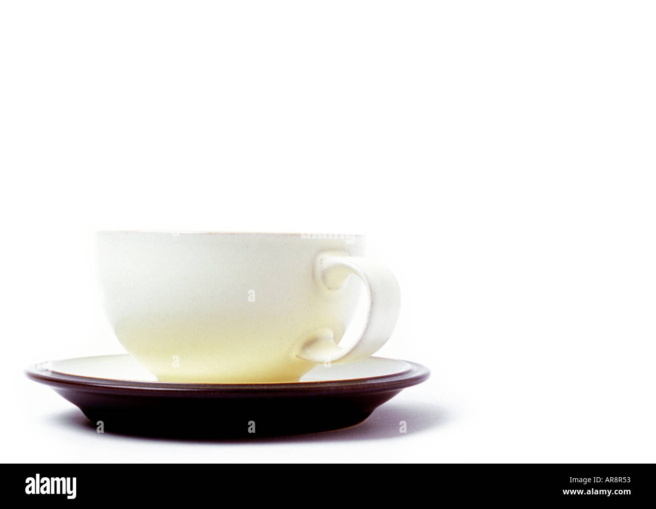 Cream coloured coffee cup and saucer on white background Stock Photo ...
