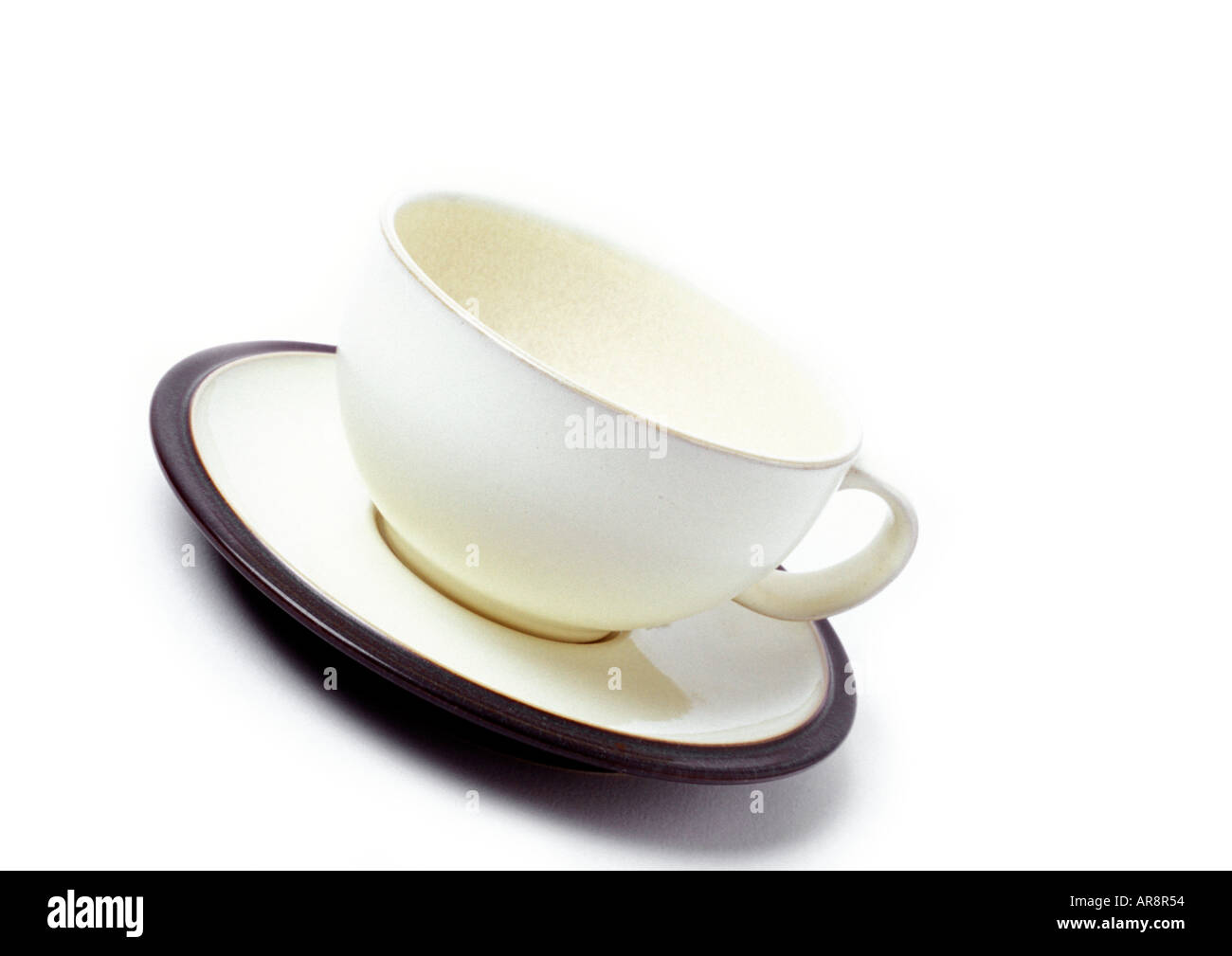 Cream coloured coffee cup and saucer on white background Stock Photo ...