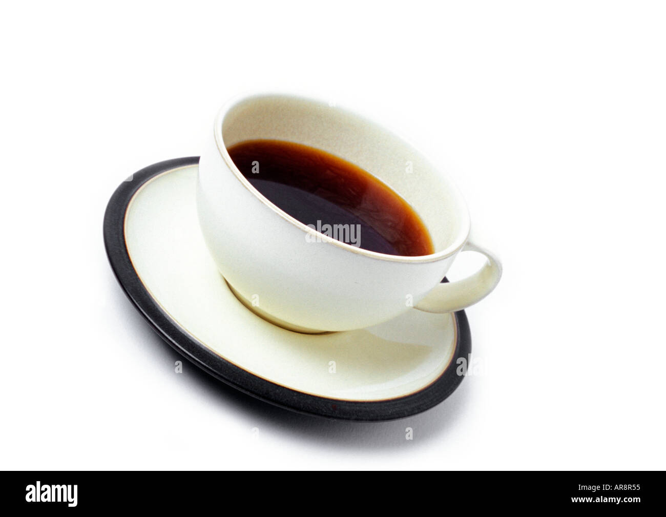 Cream coloured coffee cup and saucer on white background Stock Photo ...