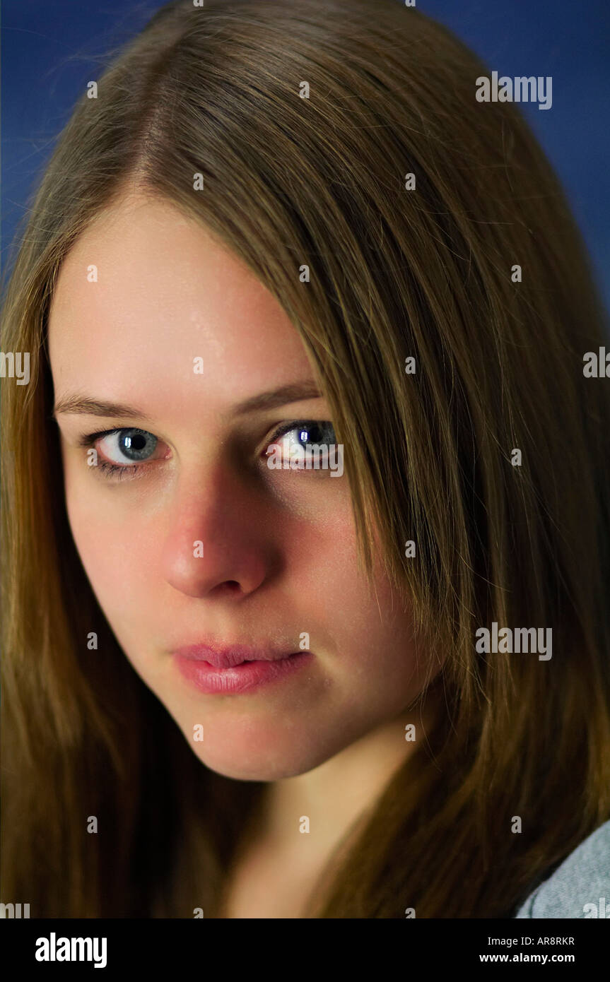 A young woman with a serious look close up showing face and hair Stock ...