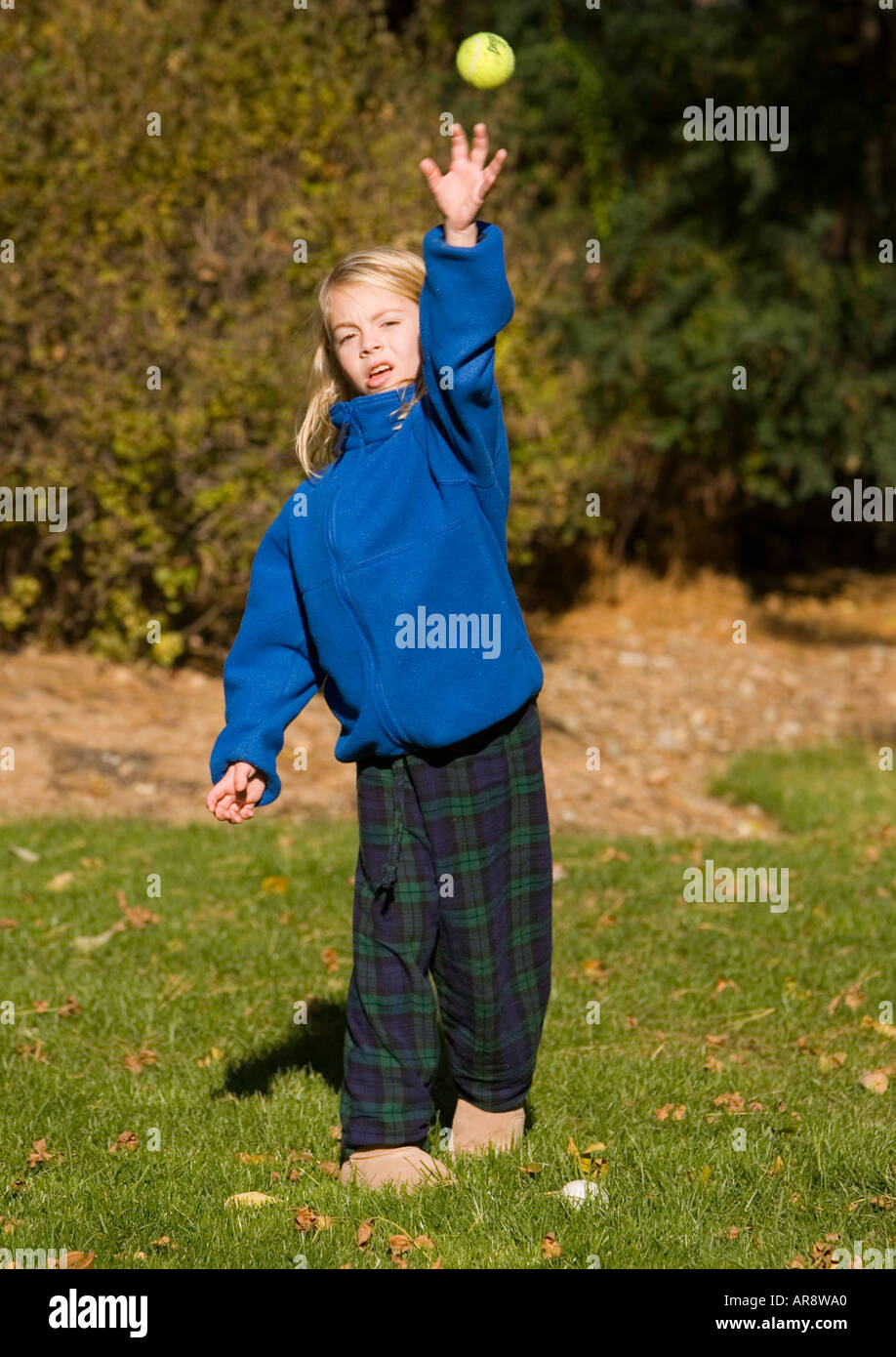 Young girl throwing a ball Stock Photo - Alamy