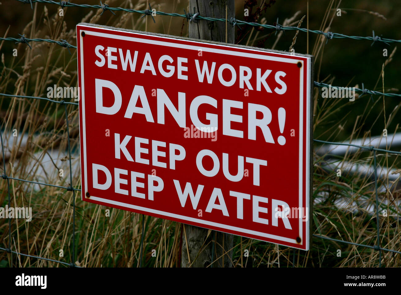 Danger sign at sewage works warning of deep water Stock Photo - Alamy